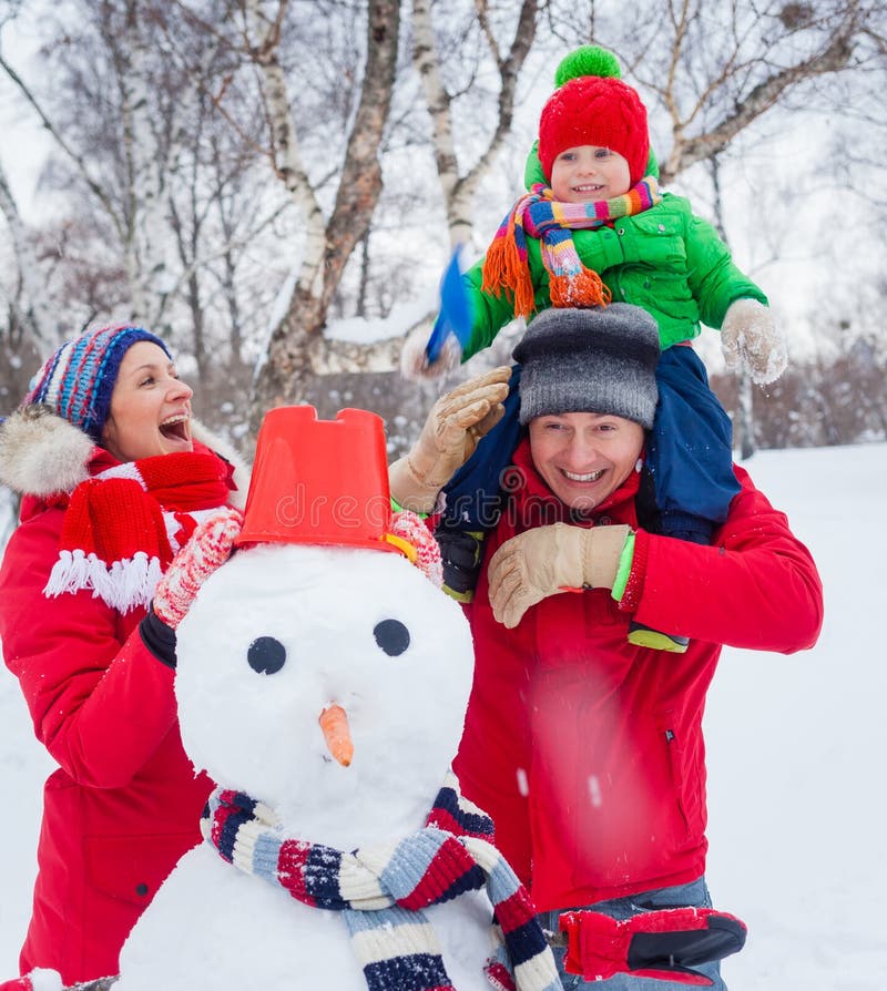 Family with a snowman stock photo. Image of parent, beautiful - 63484032