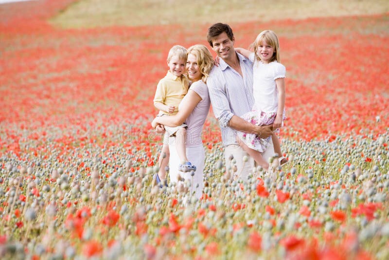 Family Standing in Poppy Field Smiling Stock Photo - Image of ...
