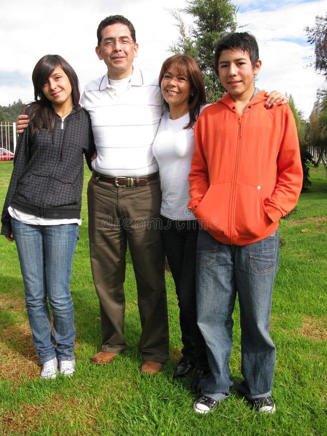 Family stands on grass stock image. Image of home, grass - 12807459