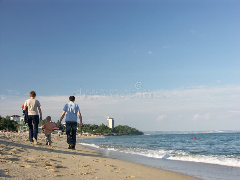 Family Stroll Along Seashore Stock Image - Image of together, joyful ...