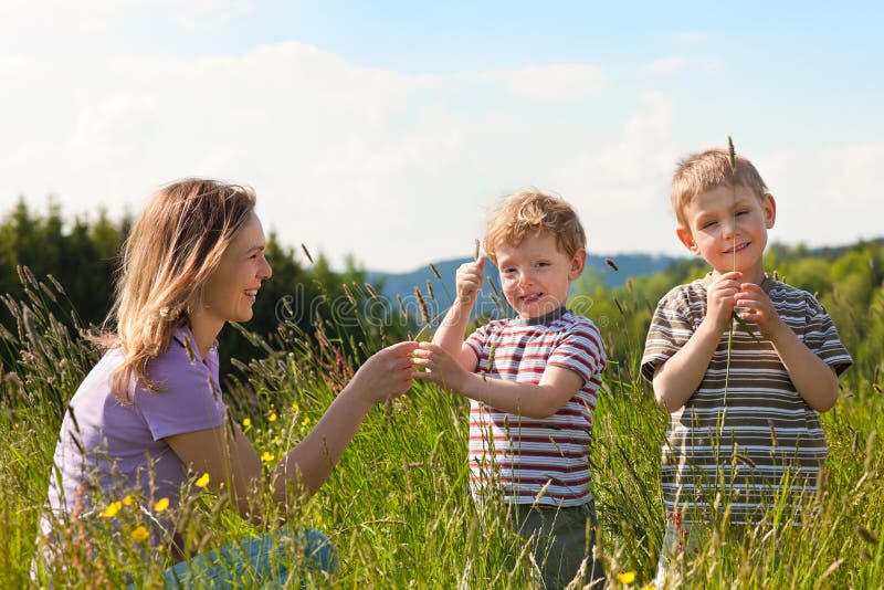 Three Kids Playing on a Grass Stock Image - Image of kids, look: 42628363