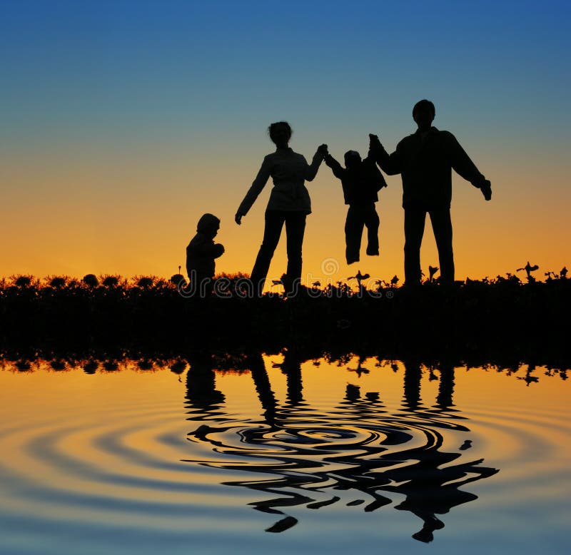 Family on sunset pond stock photo. Image of meadow, people - 4597638