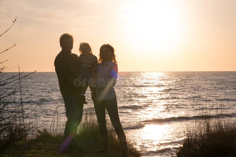 Family at Sunset by the Sea Stock Image - Image of happiness, evening ...