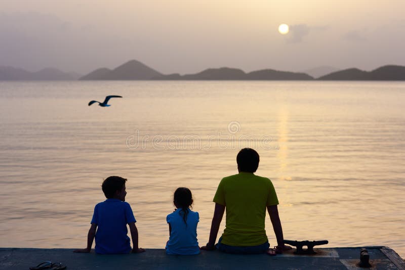 Family sunset silhouettes stock photo. Image of brother - 47430020