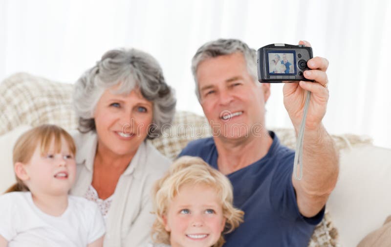 Family Taking a Photo of Themselves Stock Image - Image of home, health ...