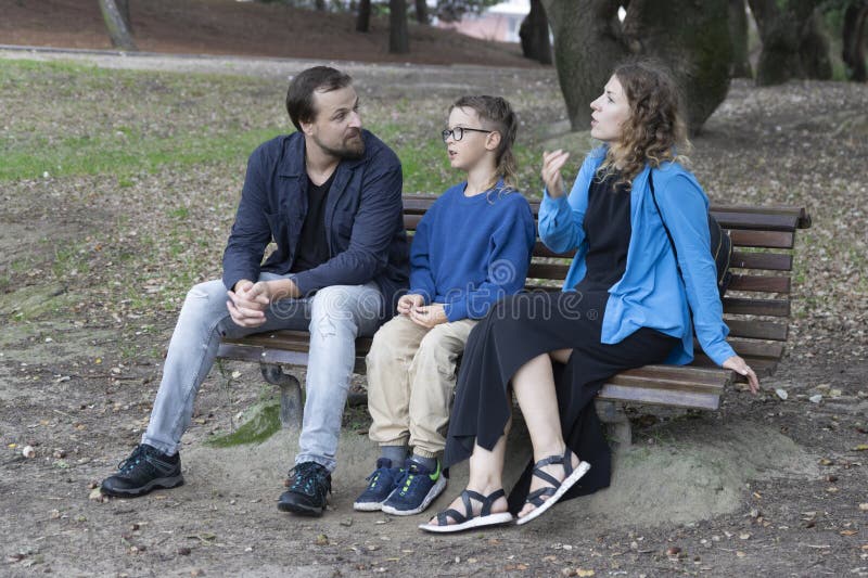 Family Talking and Discussing Issues while Sitting on Bench in Park ...