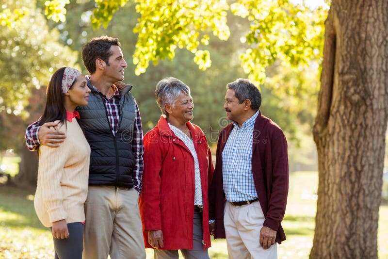 Family talking at park stock photo. Image of couple, lifestyles - 76003878