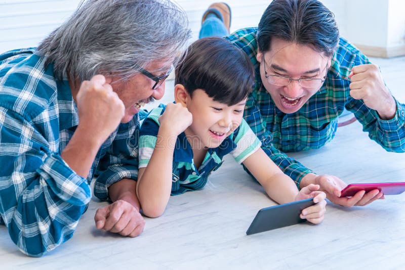 Family of Three Generation Using Smartphone Together for Modern ...