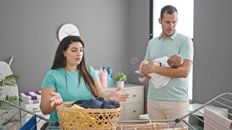 Family of Three Hanging Clothes on Clothesline at Laundry Room Stock ...