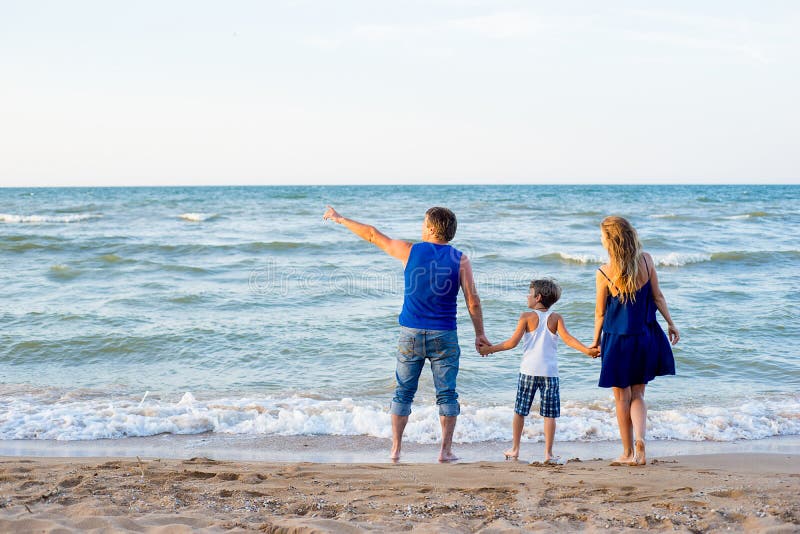 Family of Three Having Fun at the Beach Stock Photo - Image of blue ...