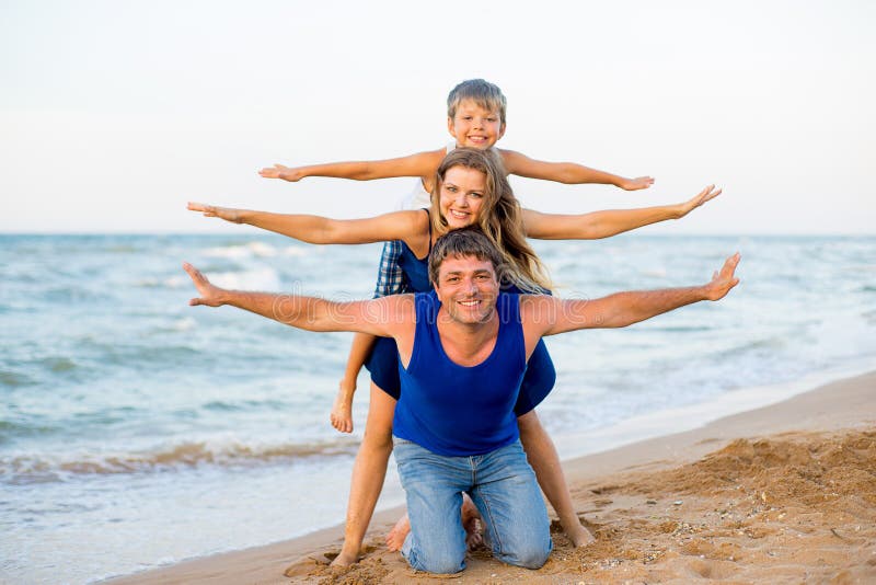 Family of Three Having Fun at the Beach Stock Photo - Image of happy ...