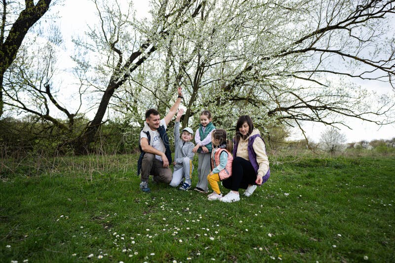 Family with Three Kids in Spring Meadow on the Background of a ...