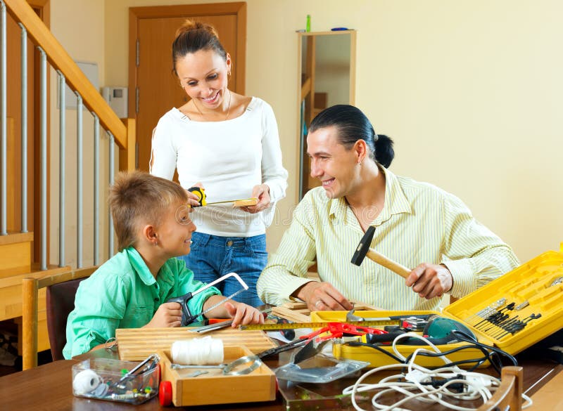 Family of Three with Teenage Boy Making Something with the Working ...