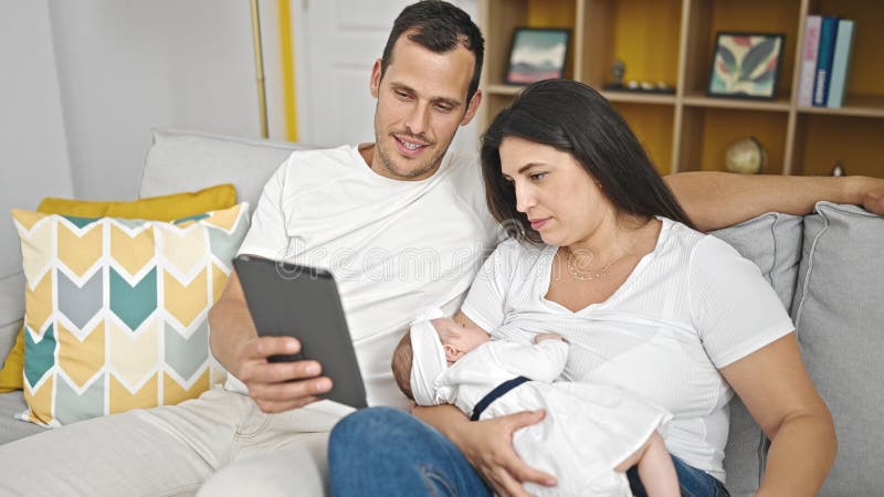 Family of Three Using Touchpad Sitting on the Sofa at Home Stock Image ...