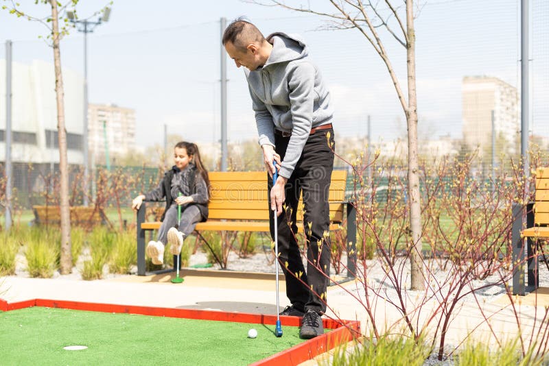 Family: Family Time Playing Mini-Golf in the Summer. Stock Photo ...