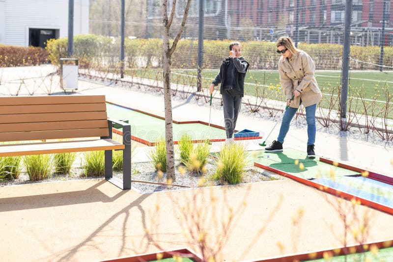 Family: Family Time Playing Mini-Golf in the Summer. Stock Photo ...