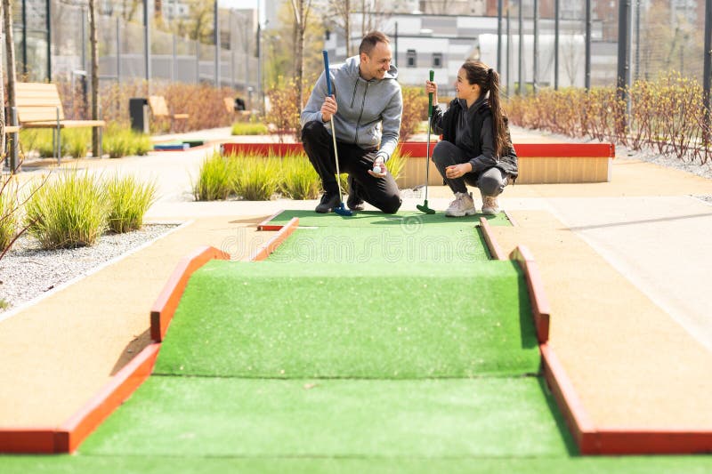 Family Time Playing Mini-Golf in the Summer Stock Image - Image of ...