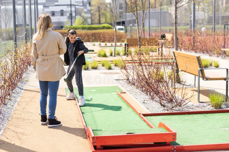 Family Time Playing Mini-Golf in the Summer Stock Image - Image of ...
