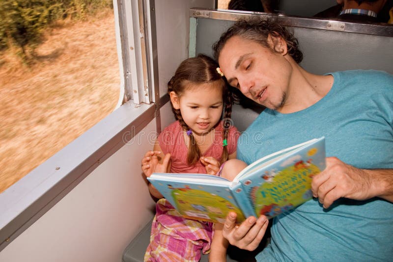 Family on the Train Reading a Book Stock Photo - Image of girl, nature ...