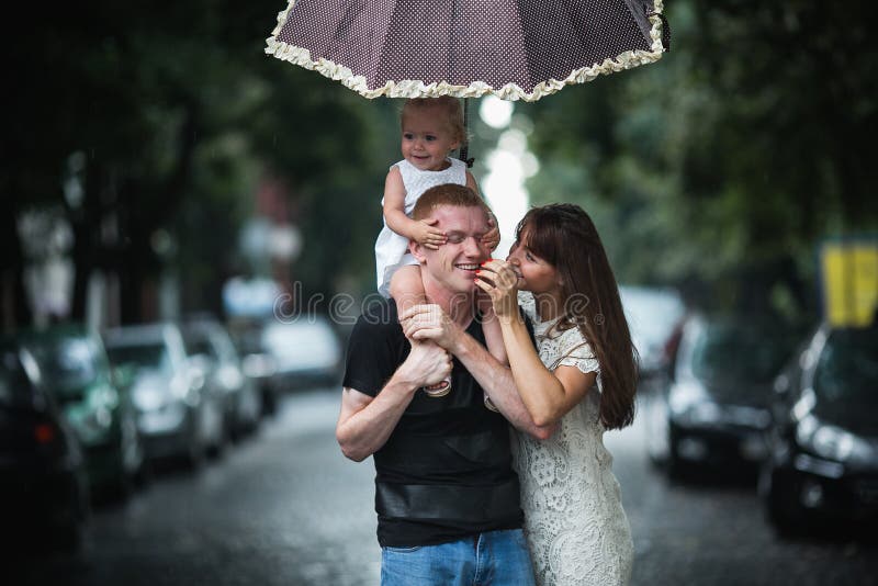 Family under the rain stock image. Image of green, group - 50589373