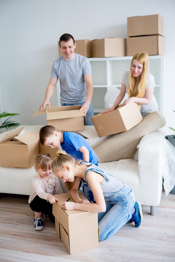 Family unpacking boxes stock image. Image of horizontal - 90952657
