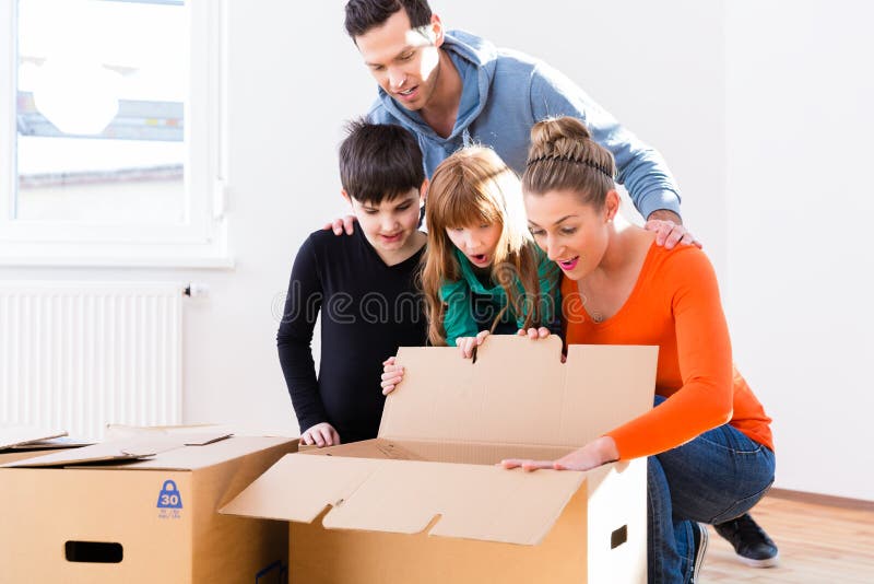 Family unpacking moving boxes in new home - Stock Image - Everypixel