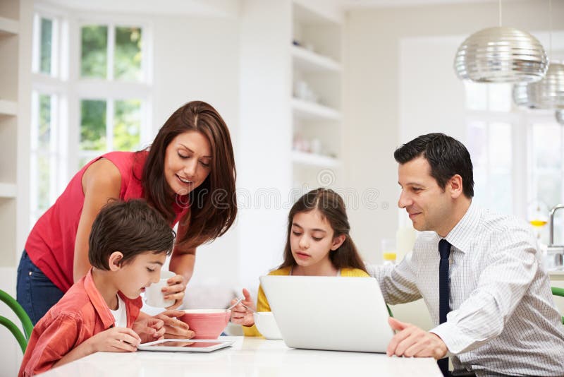 Family Using Gadgets Whilst Eating Breakfast Stock Image - Image of ...