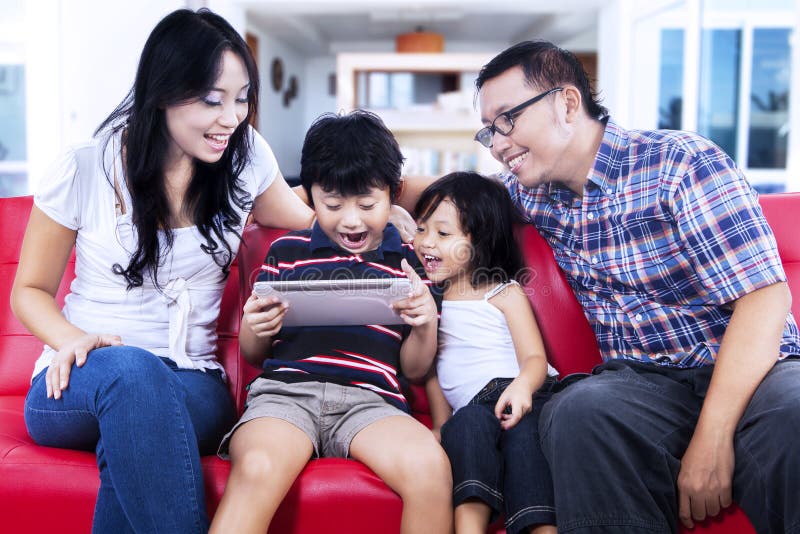 Family Using Digital Tablet Stock Photo - Image of electronic, looking ...