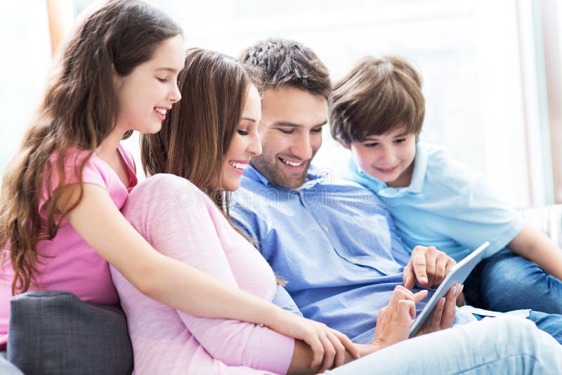 Family Using Digital Tablet at Home Stock Image - Image of bonding, house: 55150853