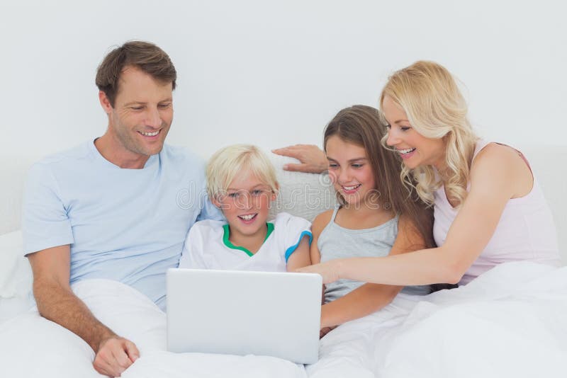Family using a laptop stock image. Image of long, happy - 31670149