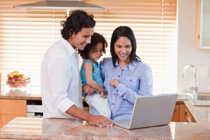 Family Using Laptop in the Kitchen Together Stock Photo - Image of ...