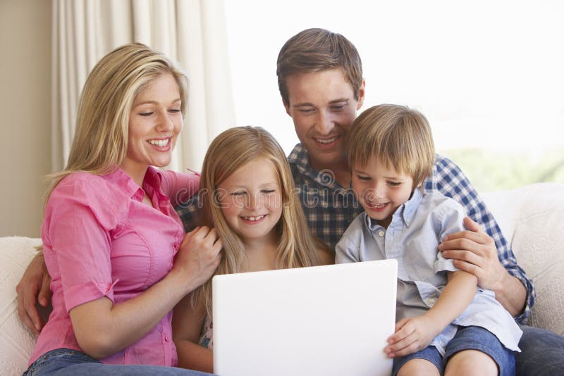 Family Using Laptop on Sofa at Home Stock Image - Image of computer ...