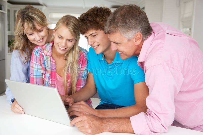 Family Using Laptop on Table Stock Photo - Image of interests, daughter ...