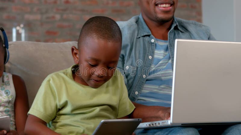 Family Using Media Devices on the Couch Stock Footage - Video of ...