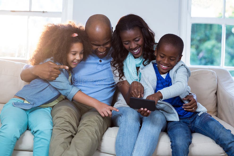 Family using mobile phone stock image. Image of cheerful - 78674075