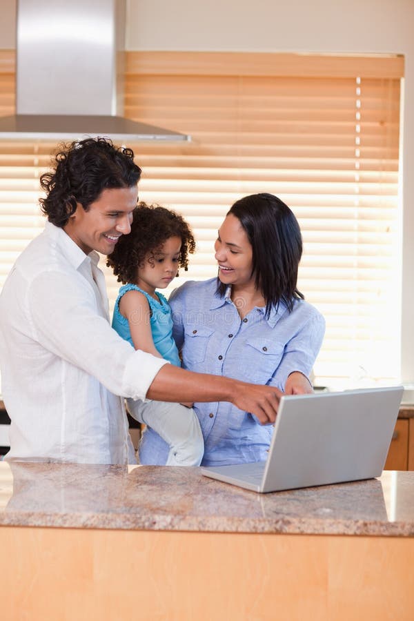 Family Using Notebook in the Kitchen Together Stock Photo - Image of ...