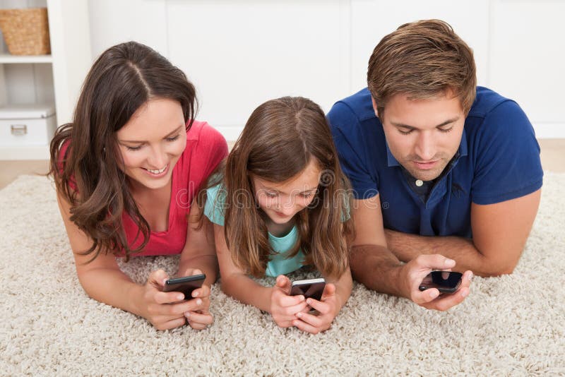 Family Using Smart Phones at Home Stock Photo - Image of horizontal ...