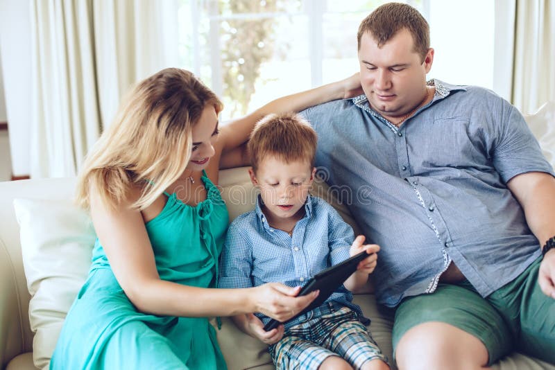Family Using Tablet in Living Room Stock Image - Image of portable ...