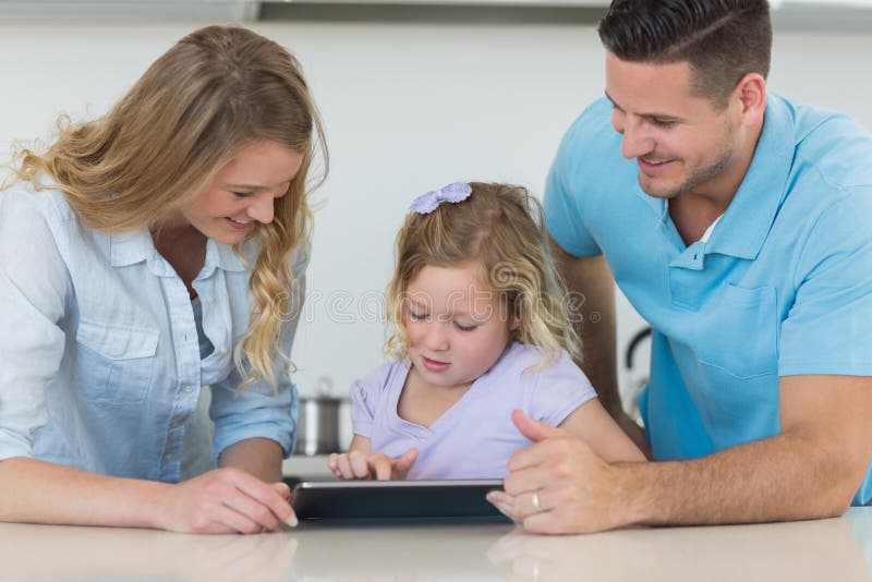 Family Using Tablet PC at Table Stock Photo - Image of table, three ...