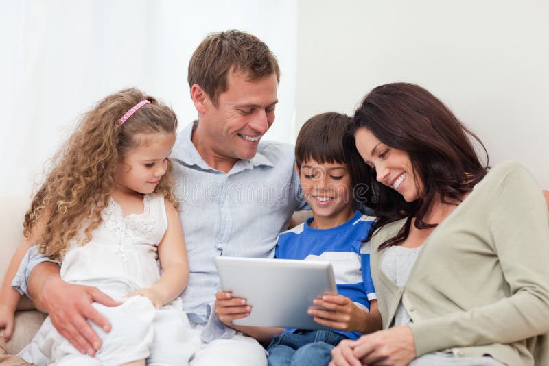 Family Using Tablet on the Sofa Stock Image - Image of happiness, adult ...