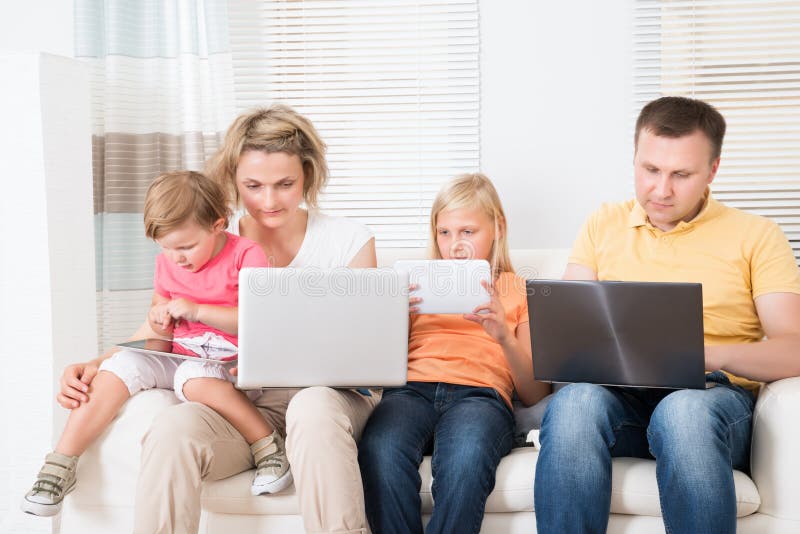 Family Using Tablets and Computers Stock Photo - Image of indoors ...