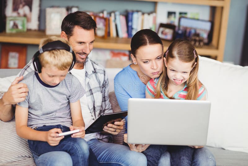 Family Using Technologies on Sofa Stock Photo - Image of childhood ...
