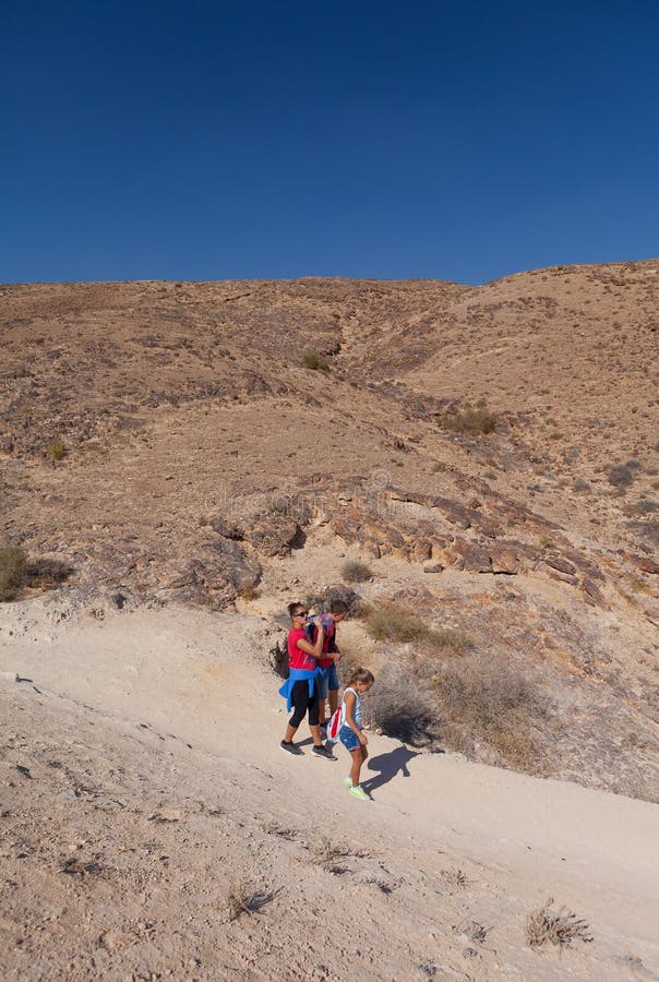 Family walk in the desert stock photo. Image of east - 35092526