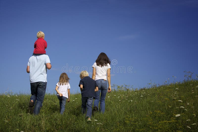 Family Walking in Meadow, View from Behind. Stock Photo - Image of ...