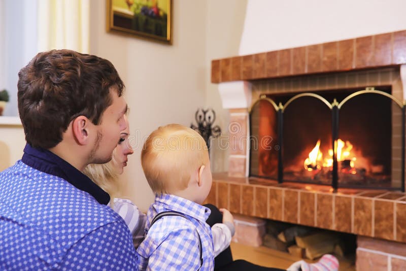Family Warmed by the Fireplace Sitting on the Couch Stock Image - Image ...