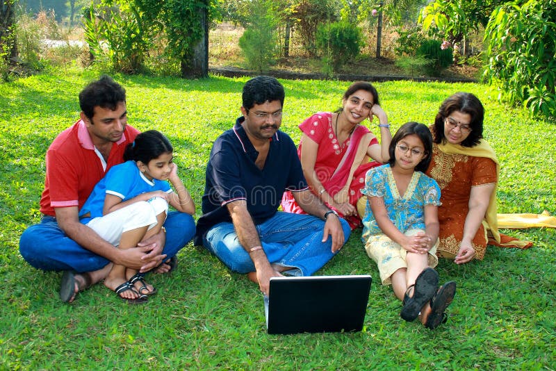 Family Watching the Laptop. Stock Image - Image of casual, grass: 7176071