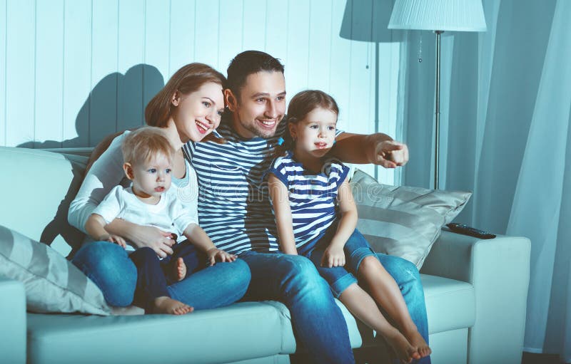 Family Watching Television at Home on Sofa Stock Photo - Image of ...
