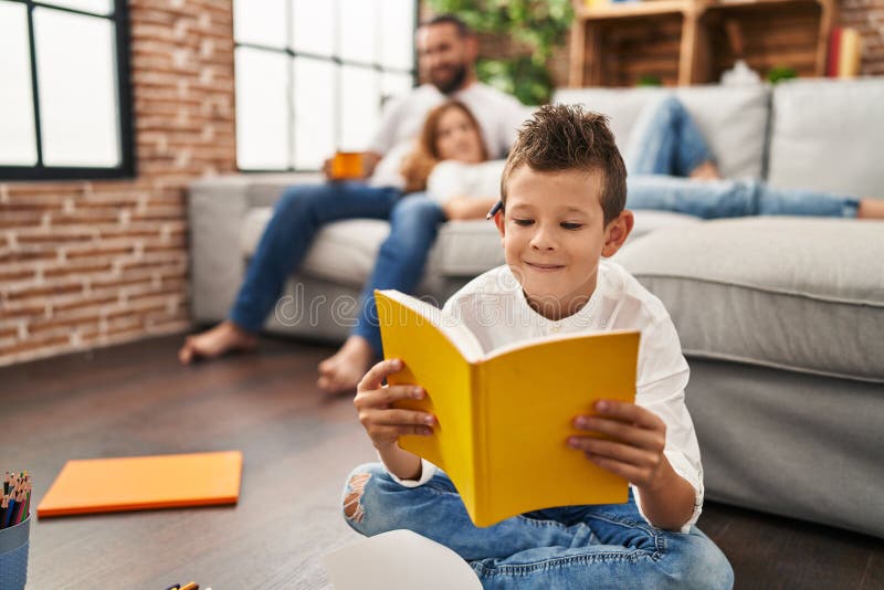 Family Watching Tv and Son Reading Book at Home Stock Image - Image of ...