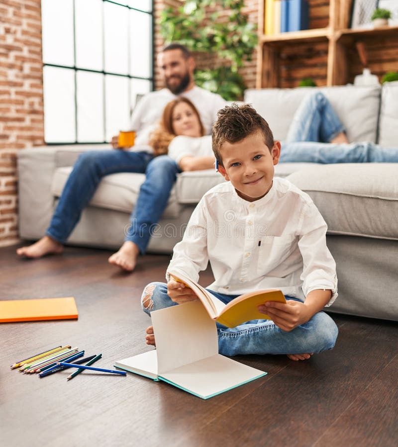 Family Watching Tv and Son Reading Book at Home Stock Image - Image of ...