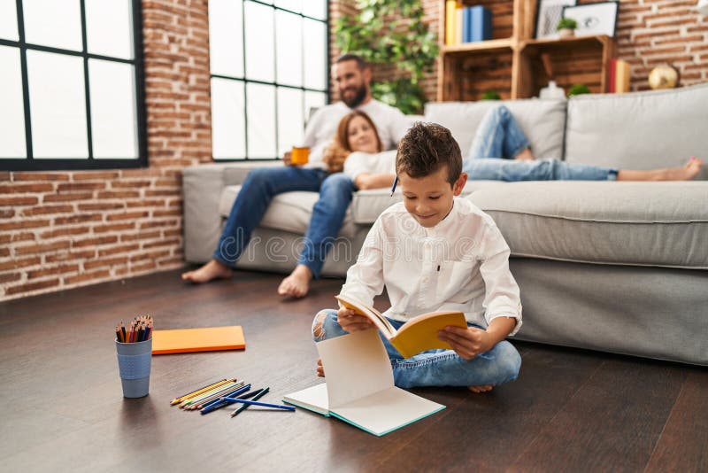 Family Watching Tv and Son Reading Book at Home Stock Image - Image of ...